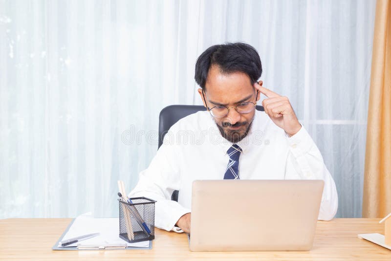 Businessman Thinking and Focus on this Work Seriously with His Computer ...