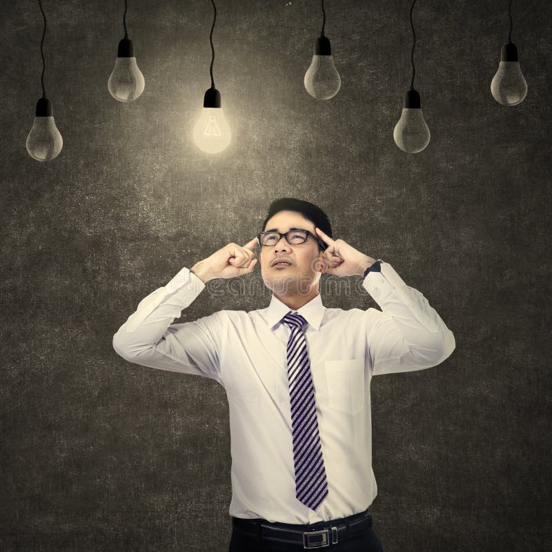 Businessman Thinking Under Light Bulb Stock Photo - Image of ...