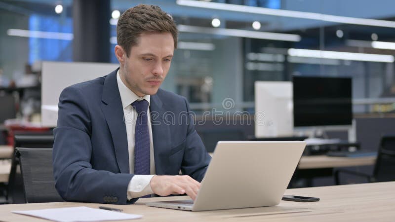 Businessman Thinking while Working on Laptop in Office Stock Image ...