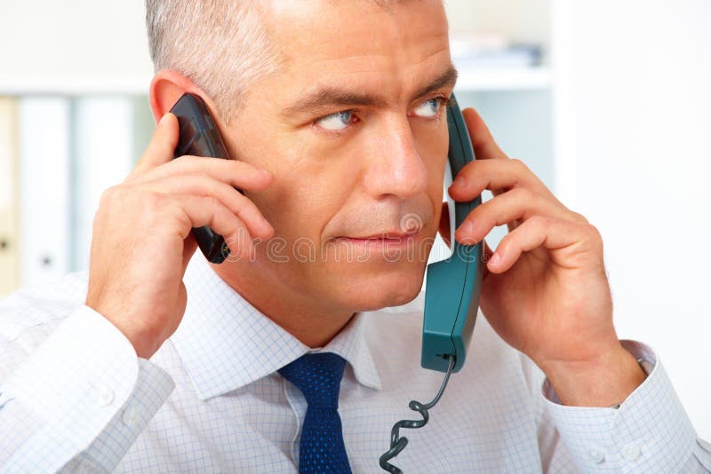 Businessman with Two Phones Stock Image - Image of aged, corporate ...