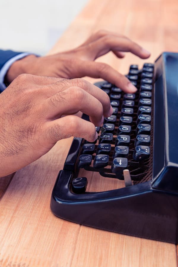 Businessman Typing on Typewriter at Wooden Desk Stock Photo - Image of ...
