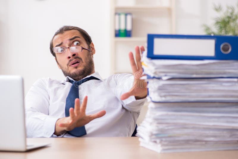 Young Businessman Unhappy with Excessive Work in the Office Stock Photo ...