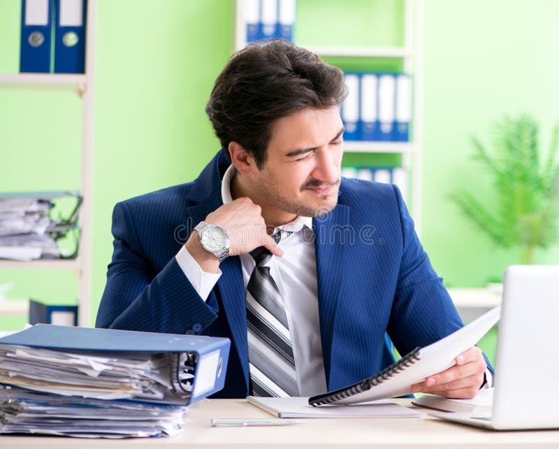 Businessman Unhappy with Excessive Work Sitting in the Office Stock ...