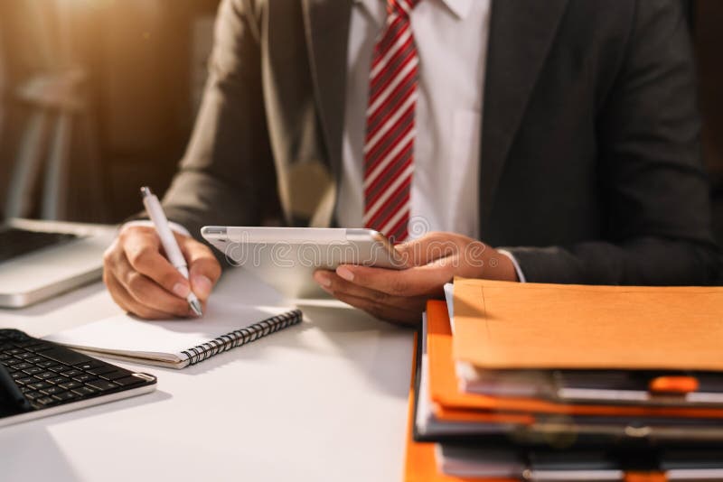 Businessman Use a Laptop Computer and Tablet with Take Notes in the ...