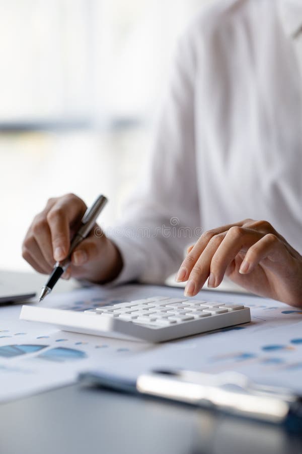 Businessman is Using a Calculator To Calculate Company Financial ... Businessman is Using a Calculator To Calculate Company Financial ...