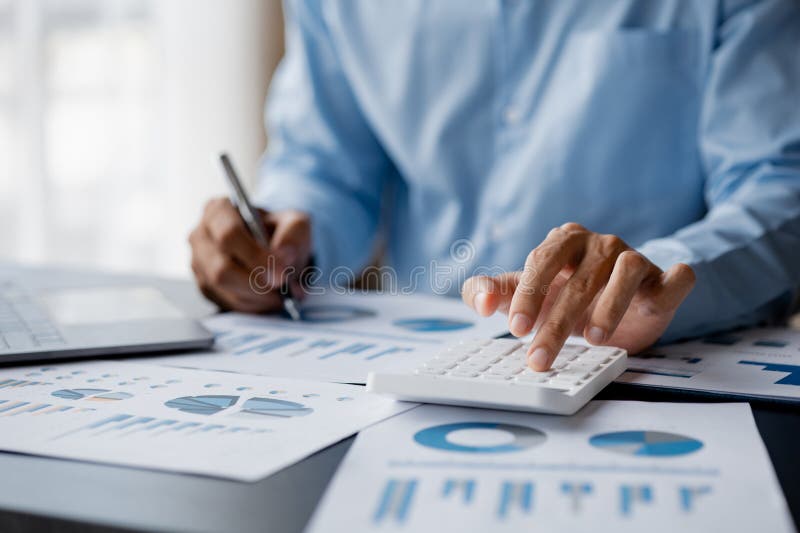 Businessman is Using a Calculator To Calculate Company Financial ... Businessman is Using a Calculator To Calculate Company Financial ...