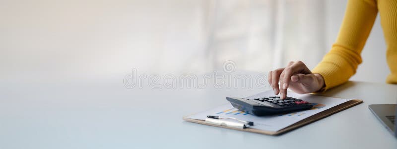 Businessman Using a Calculator To Calculate Numbers on a Company S ...