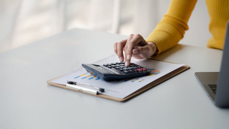 Businessman Using a Calculator To Calculate Numbers on a Company S ...