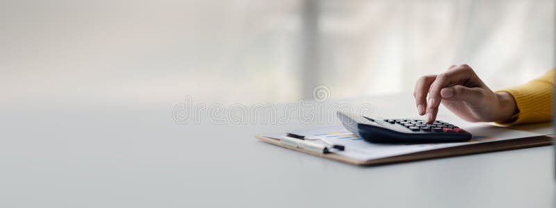 Businessman Using a Calculator To Calculate Numbers on a Company S ...