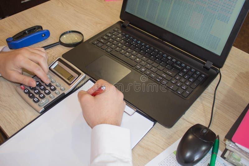 Businessman Using a Calculator To Calculate the Numbers Stock Photo ...