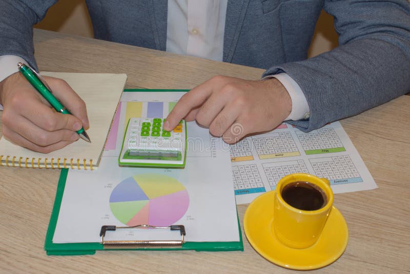 Businessman Using a Calculator To Calculate the Numbers. Businessman ...