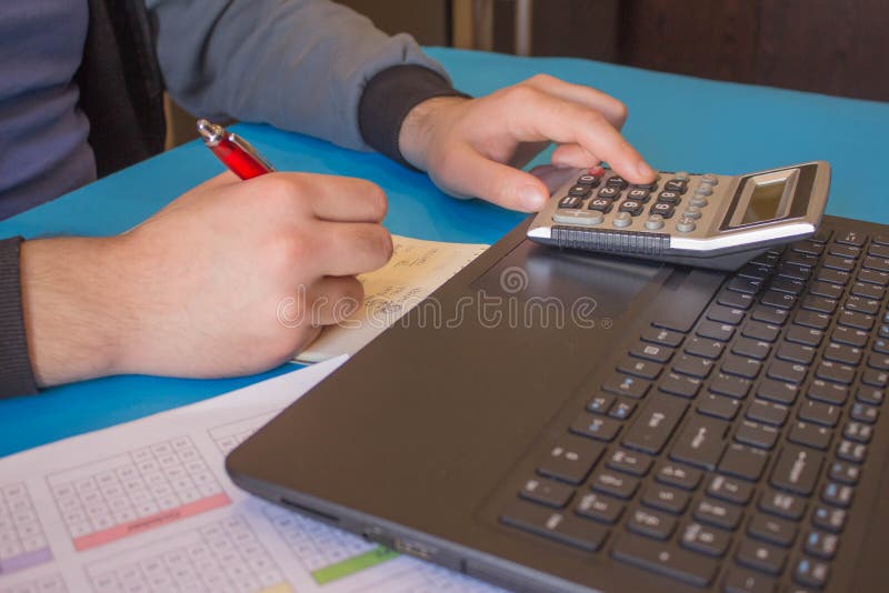 Businessman Using a Calculator To Calculate the Numbers. Businessman ...