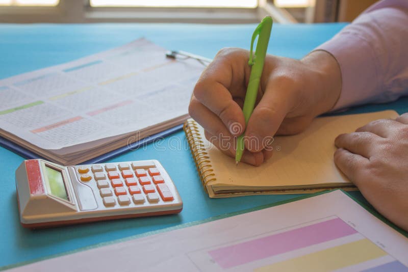 Businessman Using a Calculator To Calculate the Numbers. Businessman ...