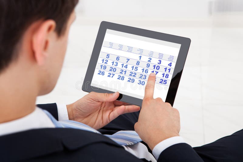 Businessman Using Calendar on Digital Tablet in Office Stock Image ...