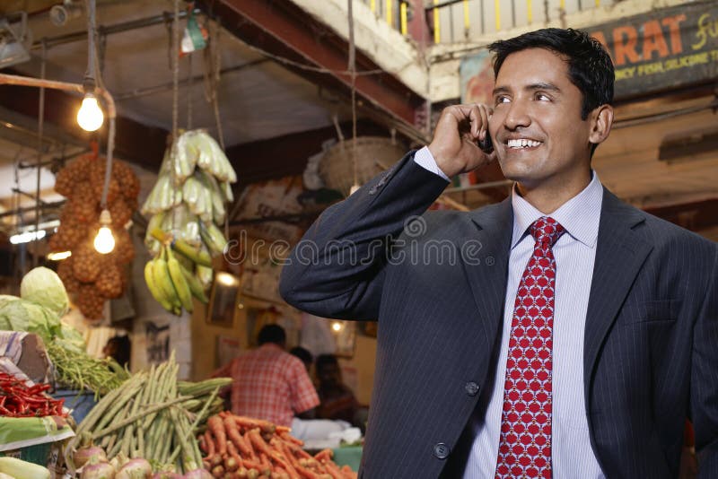 Businessman Using Cell Phone in Bazaar Stock Image - Image of ...
