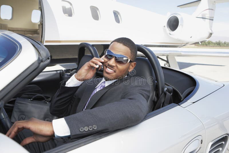 Businessman Using Cell Phone in Convertible Stock Image - Image of ...