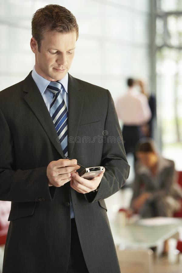 Businessman Using Cellphone with Stylus in Office Stock Image - Image ...