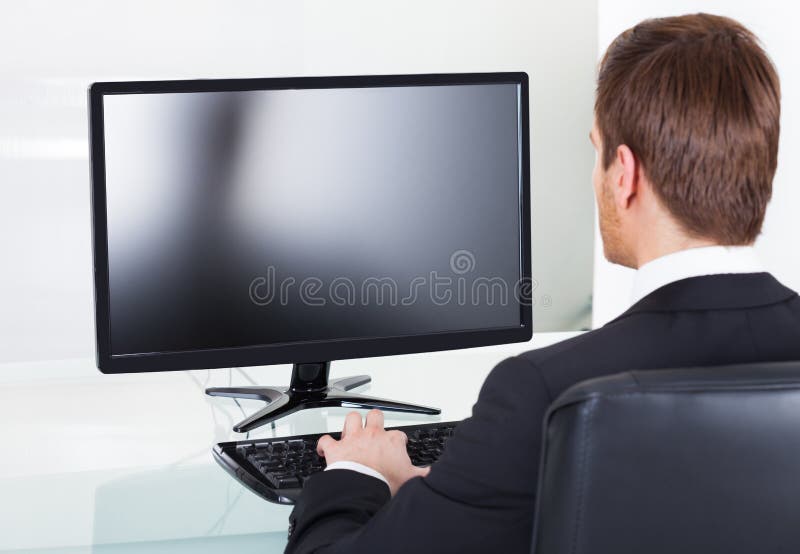 Businessman Using Computer at Office Desk Stock Photo - Image of ...
