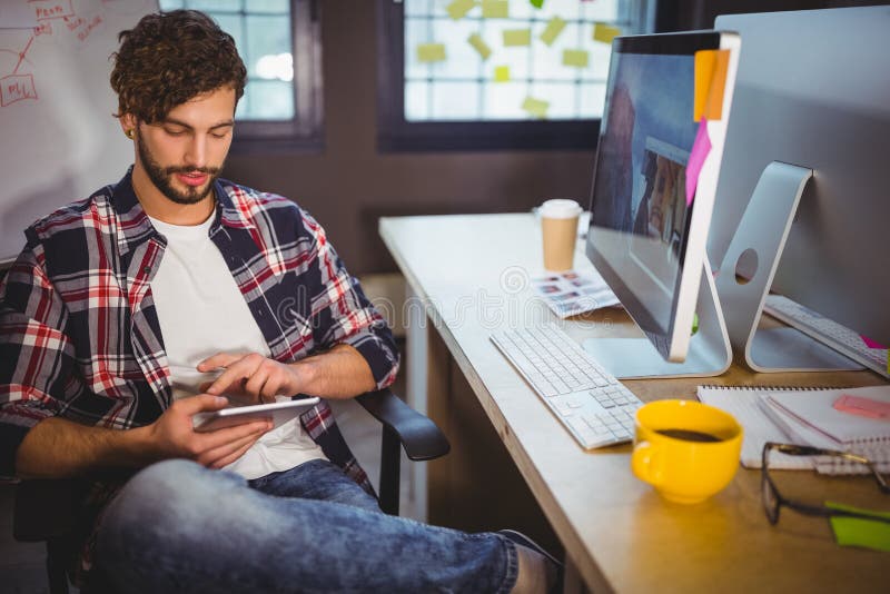 Businessman Using Digital Tablet by Computer Desk Stock Image - Image ...