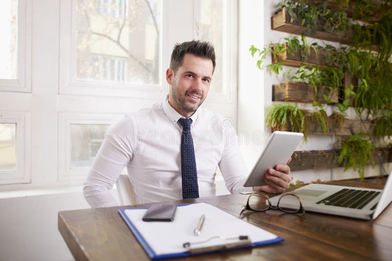 Businessman Using Digital Tablet and Computer while Sitting at Desk and ...
