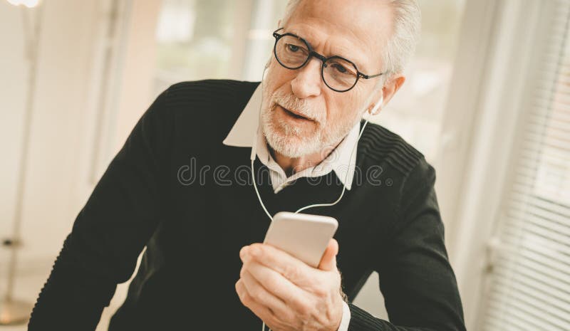 Businessman Using Earphones during Conversation on Mobile Phone Stock ...