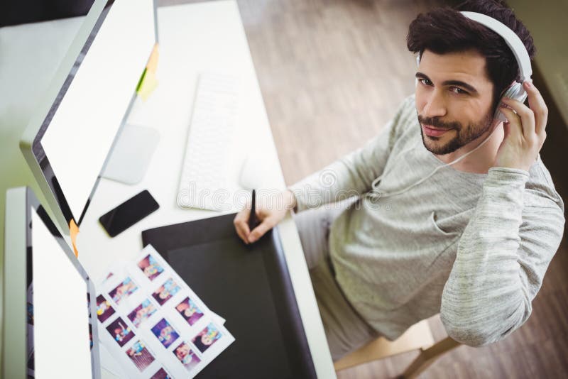 Man Using Headphones To Sing Along To Music while Resting a Tree Stock ...