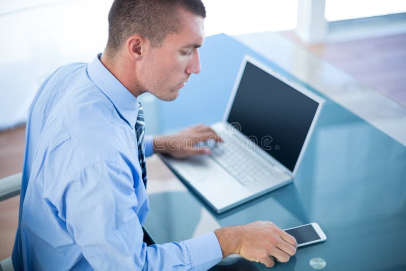 Businessman Using His Laptop and His Smartphone Stock Photo - Image of ...