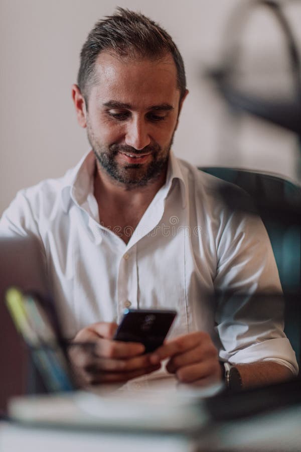 A Businessman Using on His Smartphone while Seated in an Office ...