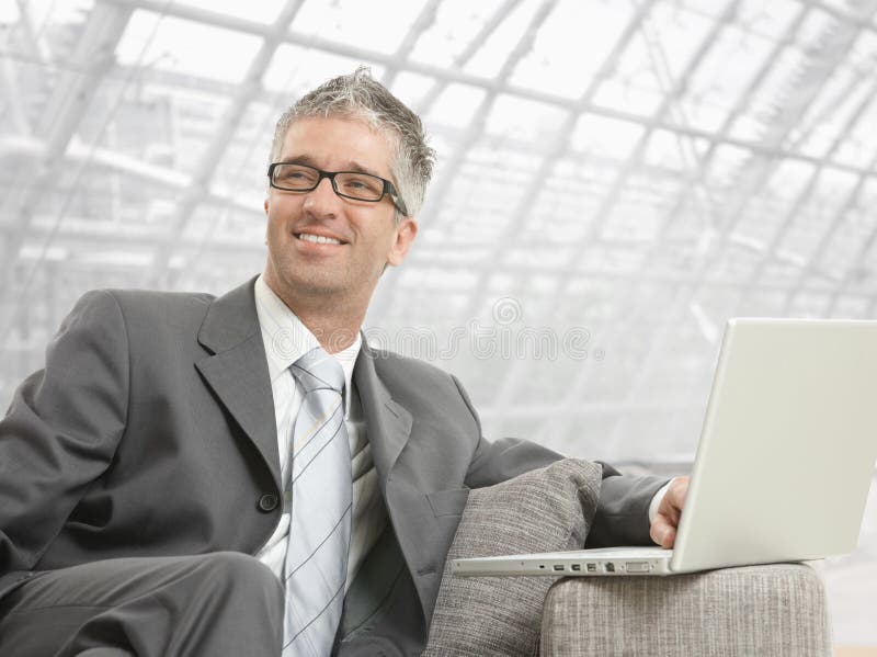 Businessman using laptop stock image. Image of glasses - 10674149