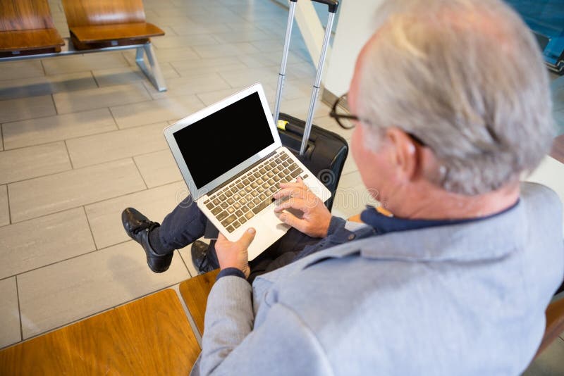 Businessman Using Laptop in Airport Terminal Stock Photo - Image of ... Businessman Using Laptop in Airport Terminal Stock Photo - Image of ...