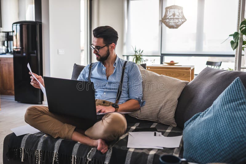 Man Working on Laptop Computer while Sitting on Sofa Stock Image ...