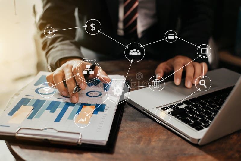 Businessman Using Laptop and Document on Desk in Office with Virtual ...