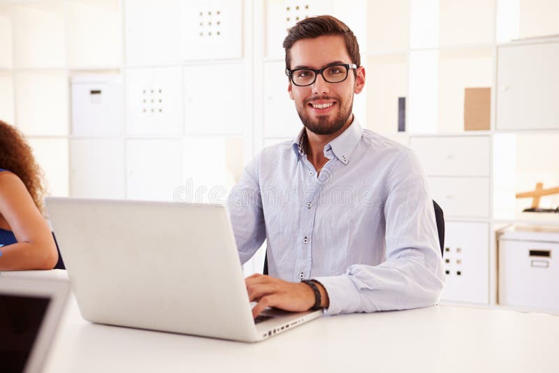 Businessman Using Laptop in Office of Start Up Business Stock Photo ...