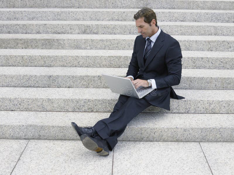 Businessman Climbing Office Steps while Looking at Wristwatch Stock ...