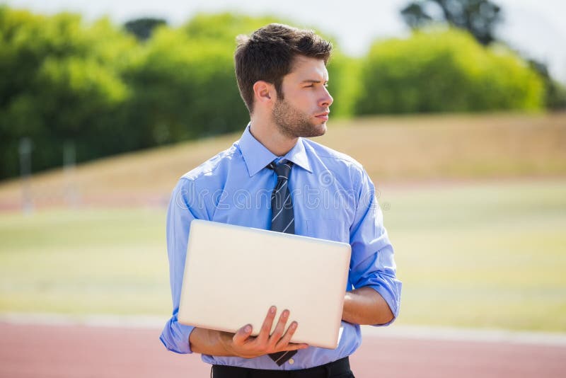 Businessman Using a Laptop on the Running Track Stock Photo - Image of ...