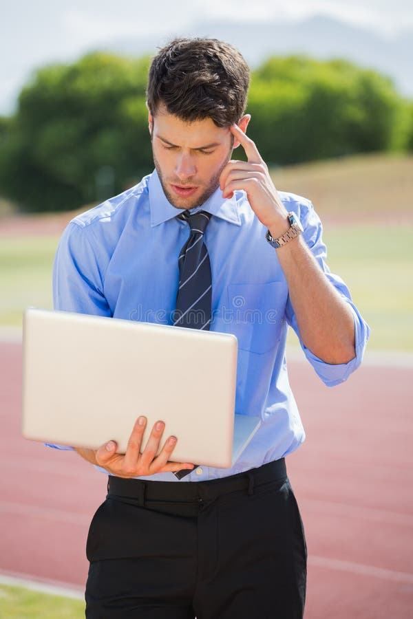 Businessman Using a Laptop on the Running Track Stock Photo - Image of ...