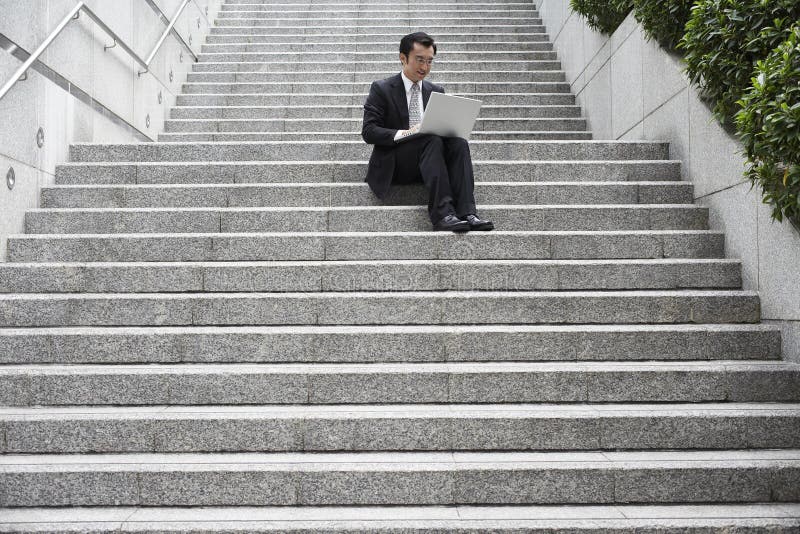 Businessman Using Laptop on Steps Stock Image - Image of male, adult ...