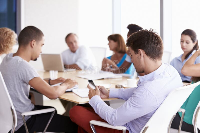 Businessman Using Mobile Phone in Boardroom Meeting Stock Image - Image ...