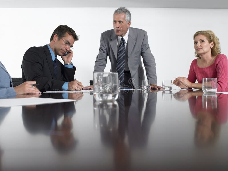 Businessman Using Mobile Phone in Conference Room Stock Image - Image ...