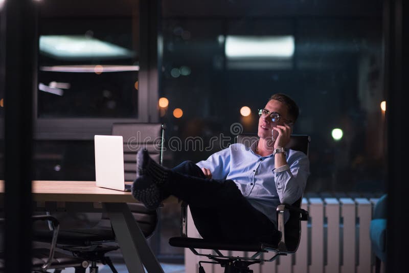Businessman Using Mobile Phone in Dark Office Stock Photo - Image of ...