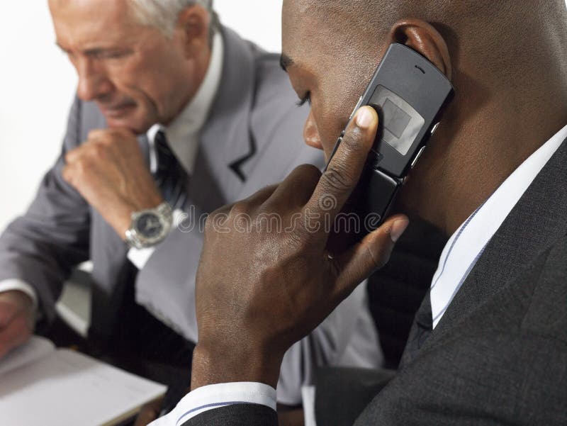 Businessman Using Mobile Phone in Meeting Stock Photo - Image of ...