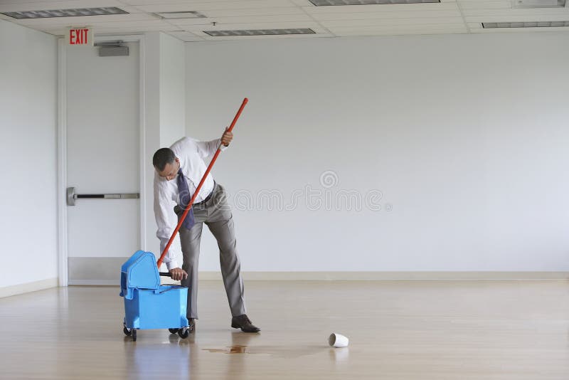 Businessman Using Mop in Empty Room Stock Photo - Image of ...