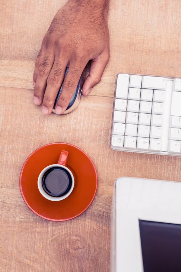Businessman Using Mouse by Coffee Cup while Working at Desk Stock Image ...