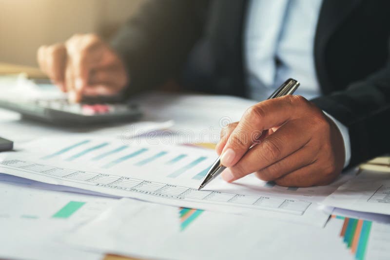 Businessman Using Pen and Calculator Working in Office. Finance Stock ...