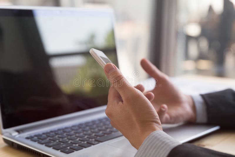 Businessman Using Smartphone and Laptop Computer in Office Stock Photo ...
