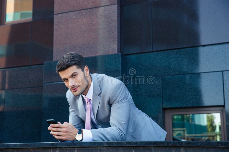 Man Holding Cellphone Outdoors on the Street. Man Using Mobile ...