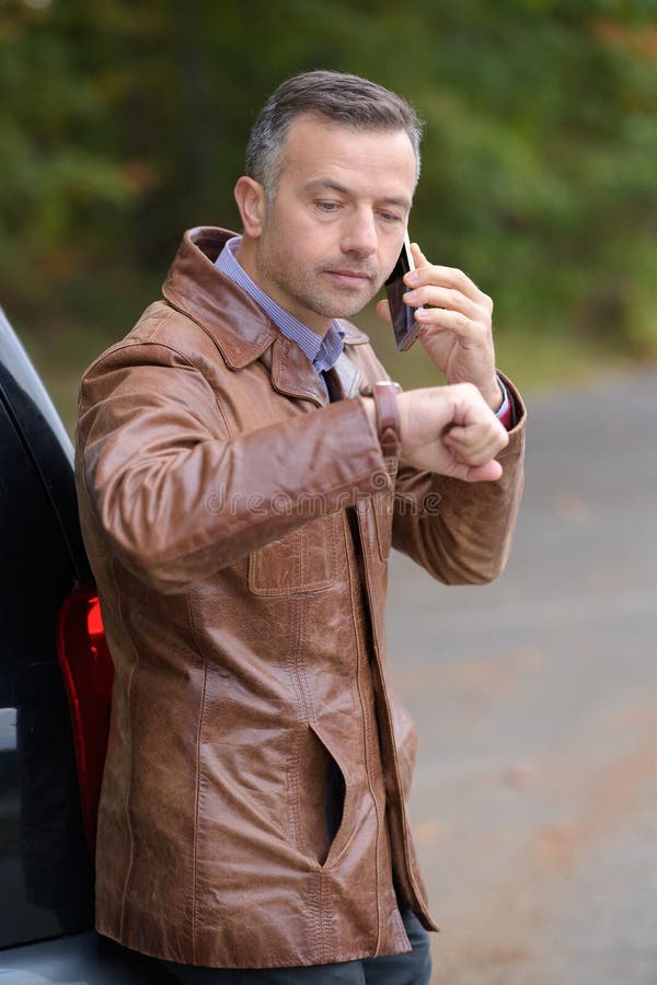 Businessman Using Smartphone and Watching Time Stock Image - Image of ...