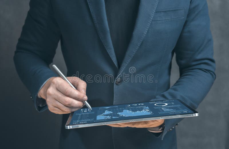 Businessman Using Tablet Analyzing Sales Data and Economic Growth Graph ...