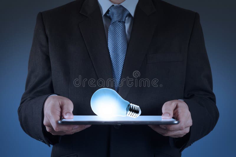 Businessman Using Tablet Computer Growing Light Bulb Stock Photo ...