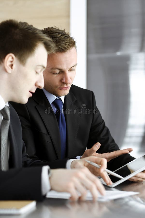 Businessman Using Tablet Computer and Work Together with His Colleague ...